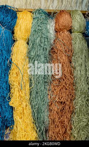 Natural wool thread dyed in color for carpet making Stock Photo - Alamy
