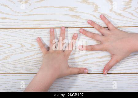 Hands making a gesture on a wooden background Stock Photo - Alamy