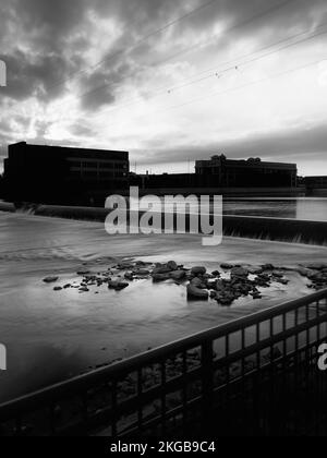Grayscale. Waterfall reflection in small clear transparent lake ...