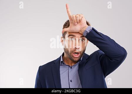Loser. Portrait of a man making a loser gesture with his hand Stock ...