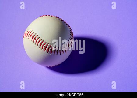 baseball ball on violet background close up with shadow Stock Photo - Alamy