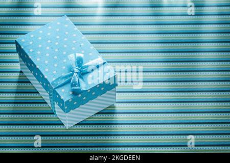 Blue gift box on stripy table cloth celebrations concept Stock Photo ...