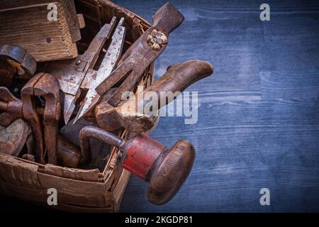 Collection of vintage rough tools in wicker box construction concept ...