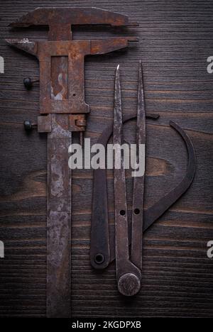Composition of old-fashioned vernier scales on vintage wooden board ...