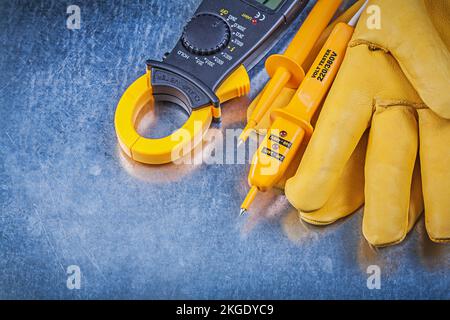 Digital ammeter electric tester dielectric rubber gloves on metallic ...