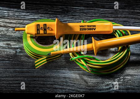 Electric tester hunk of rolled cable insulation tape on vintage wooden ...