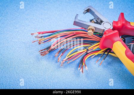 Insulated wire strippers set of electric cables on blue background ...
