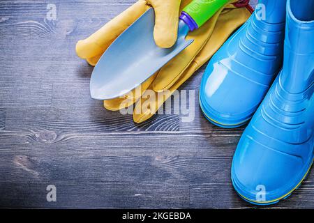 Leather safety gloves metal hand spade garden knee mat on wooden board ...