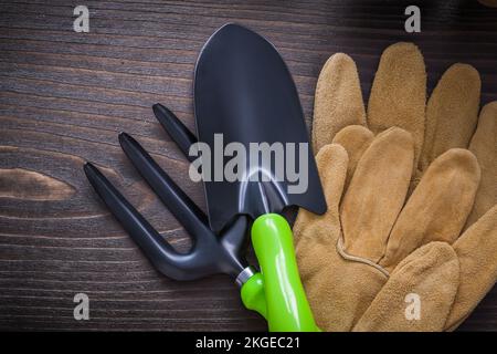 Leather safety gloves metal hand spade waterproof gumboots on wooden ...