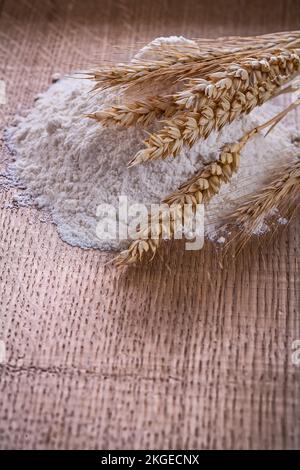ears of rye little heap of flour on wooden board food and drink concept ...