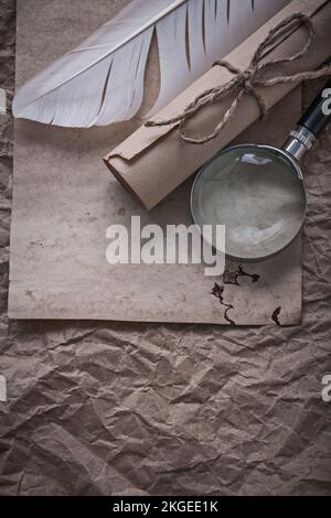 Medieval sheet feather loupe rolled document on messy crumpled paper ...