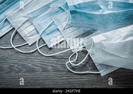 Stack of disposable sterile face masks on vintage wooden board Stock ...