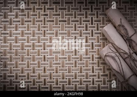 Vintage rolls of paper on wicker wooden matting copyspace Stock Photo ...