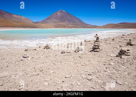 Piled stones on the Laguna Verde (Green Lagoon) at Eduardo Avaroa ...