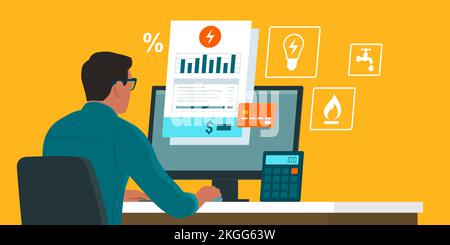 Man sitting at desk and paying his utility bills online on his computer ...