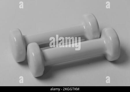 Dumbbells made of blue plastic on blue background Stock Photo - Alamy