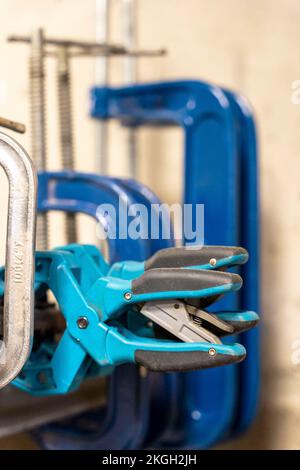 hand clamps on the welding table in the auto repair shop Stock Photo ...