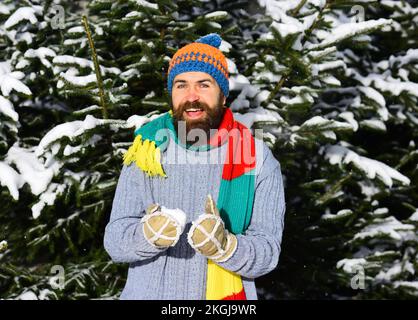 Macho with beard and mustache plays with snowball. Guy with happy face ...