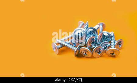 screws a lot, macro photo. Long Iron or metal screw nails on red ...