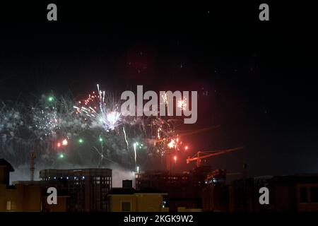 colorful fireworks at night with shadows of a construction site and ...