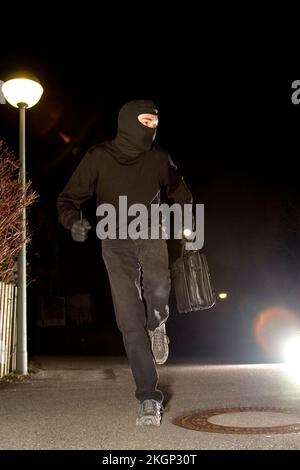 Burglar on the run Stock Photo - Alamy