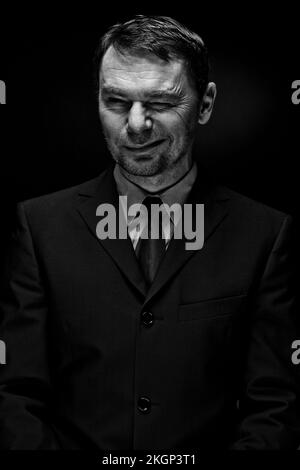 Smart Business Man Winking Stock Photo - Alamy