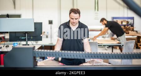 Professional worker printmaker technician operator works in printing ...