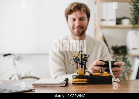 A robotic arm holding a pen Stock Photo - Alamy