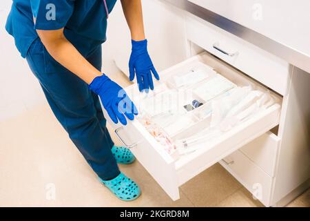 Nurse taking inventory of medical supplies at hospital Stock Photo - Alamy