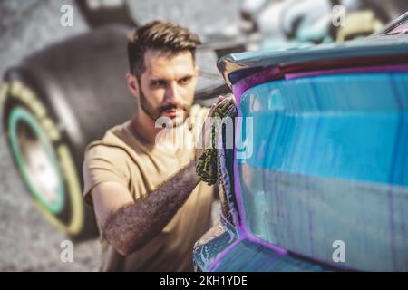 Focused auto detailer washing the taillight of a vehicle Stock Photo ...