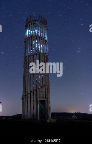 A vertical breathtaking view of Acacia lookout tower with star trails ...