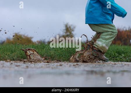 Jumping in mud puddles, it splashes properly Stock Photo - Alamy