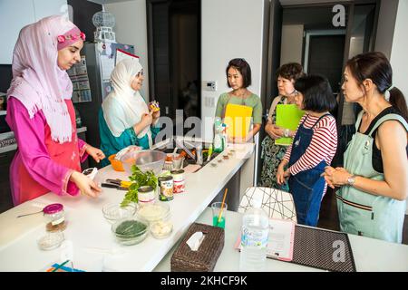 Teachers instruct at Tunisian cooking class, Shibaura, Tokyo, Japan ...