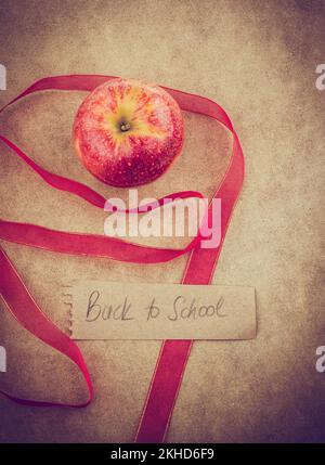 Back to school lettering with apple and a red ribbon Stock Photo - Alamy