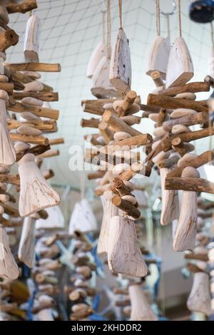Beautiful wooden fish for decoration on a a string Stock Photo - Alamy