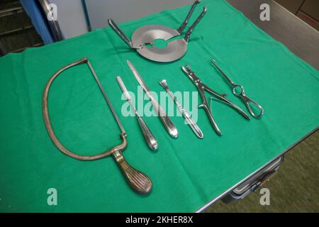 some various instruments for an amputation lie on a surgical cloth ...