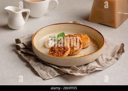 Portion of russian pancakes syrniki with cream Stock Photo - Alamy