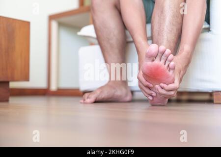 man having bunion toes or blister due to wearing narrow shoes and ...