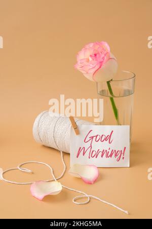 Tender pink roses with spool of white cotton rope in heart shape on ...