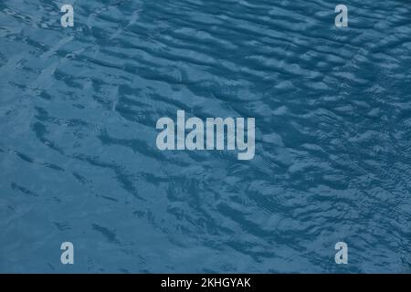 Blue swimming pool edge with refection of water ripple background Stock ...