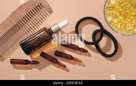 Hair brush and fish oil pills on light wooden background Stock Photo ...