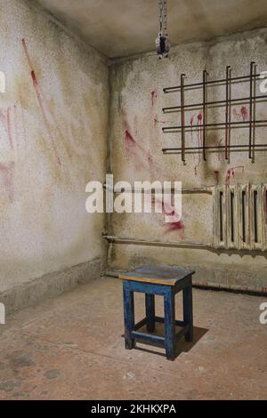 Recreation of a bloody room with chain and stool, used for torture ...