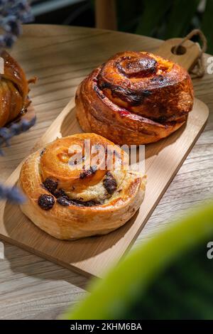 Delicious and sweet chocolate swirls on wooden background Stock Photo ...