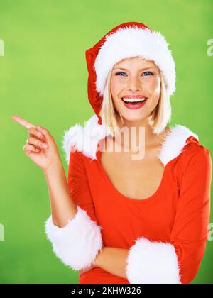 Young attractive santa displaying xmas gift Stock Photo - Alamy