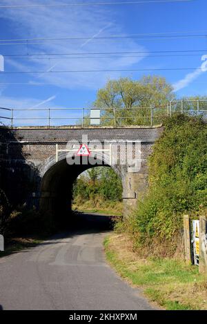 A railway bridge with limited headroom over a narrow country lane Stock ...