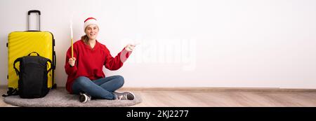 Woman traveler with suitcase in sweater yawn, stretching and raised ...