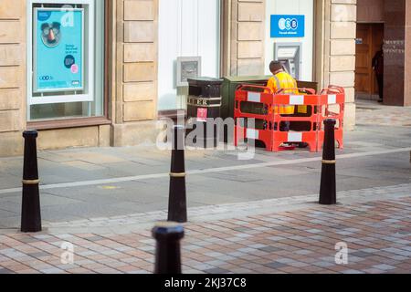Telephone engineer working at street junction box Stock Photo - Alamy