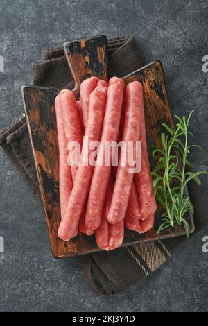 Meat beef sausages. Raw barbecue sausages with spices, vegetables and ...