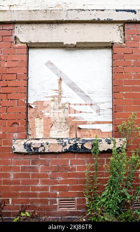 Windows are boarded up at the back of the house where three children ...