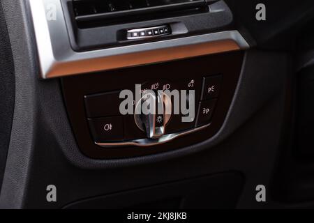 Closeup of the headlight switch control button. Lights control panel in ...